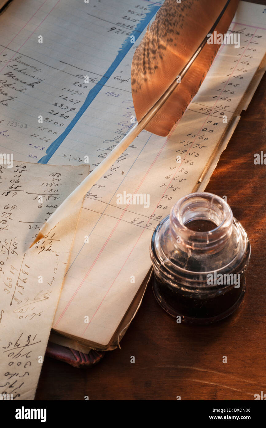 Ink feather pen and ledger Stock Photo - Alamy