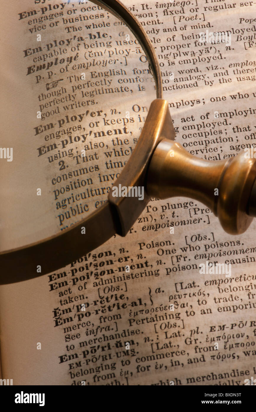 Magnifying glass over dictionary Stock Photo - Alamy