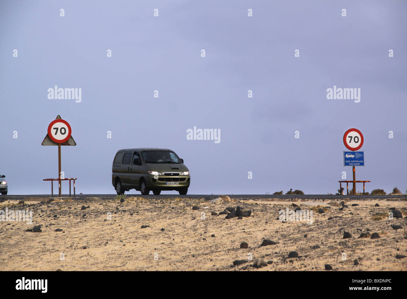 car passing 70 kph road sign on Spanish road Stock Photo - Alamy