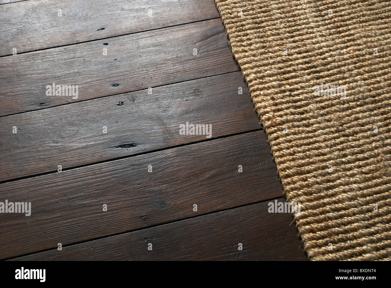 Wooden floor with rug Stock Photo - Alamy