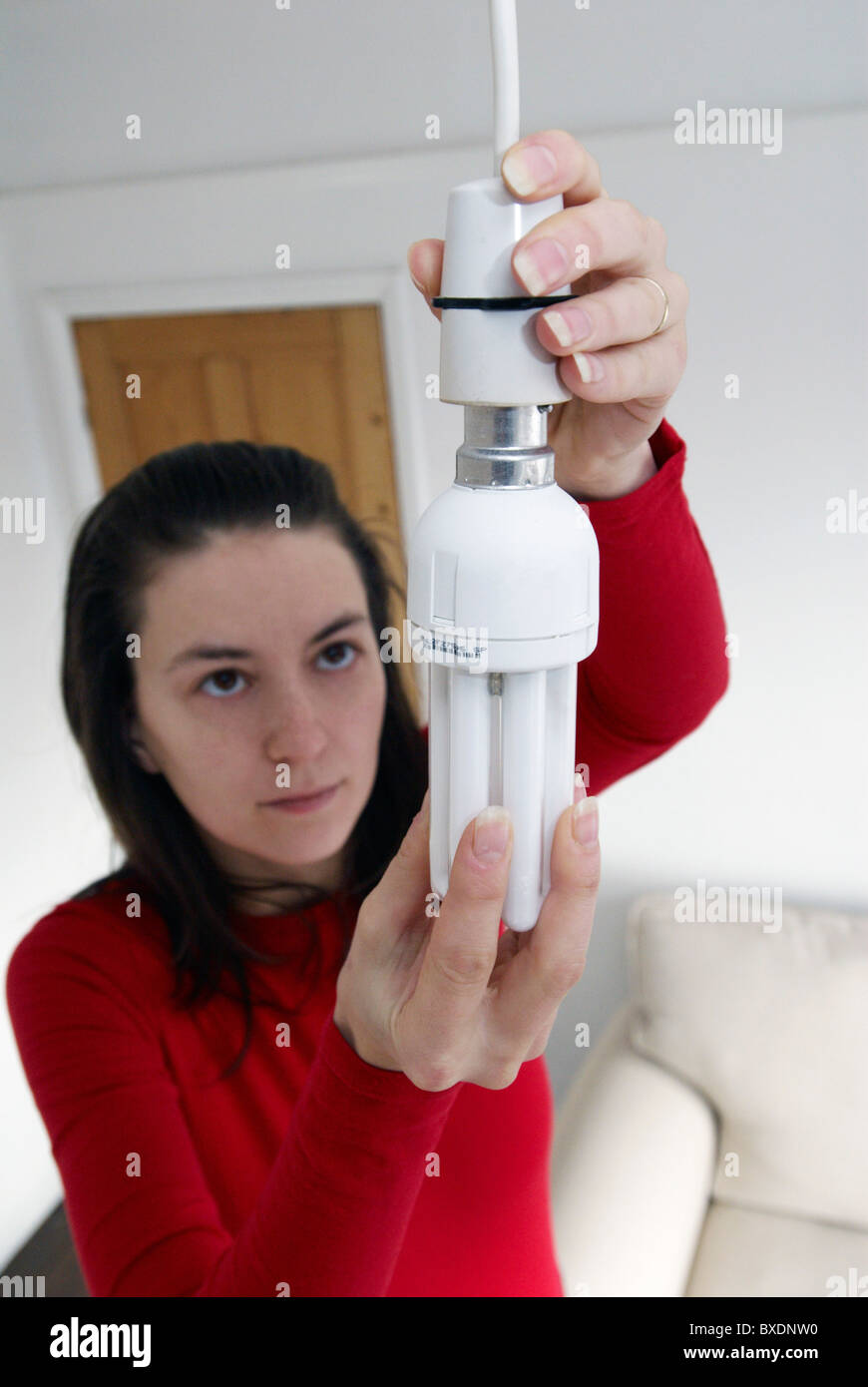 Woman putting in energy saving light bulb Stock Photo - Alamy Woman putting in energy saving light bulb Stock Photo - Alamy