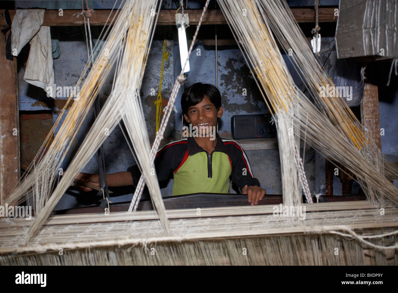 Child working at a silk factory in Varanasi, India Stock Photo - Alamy