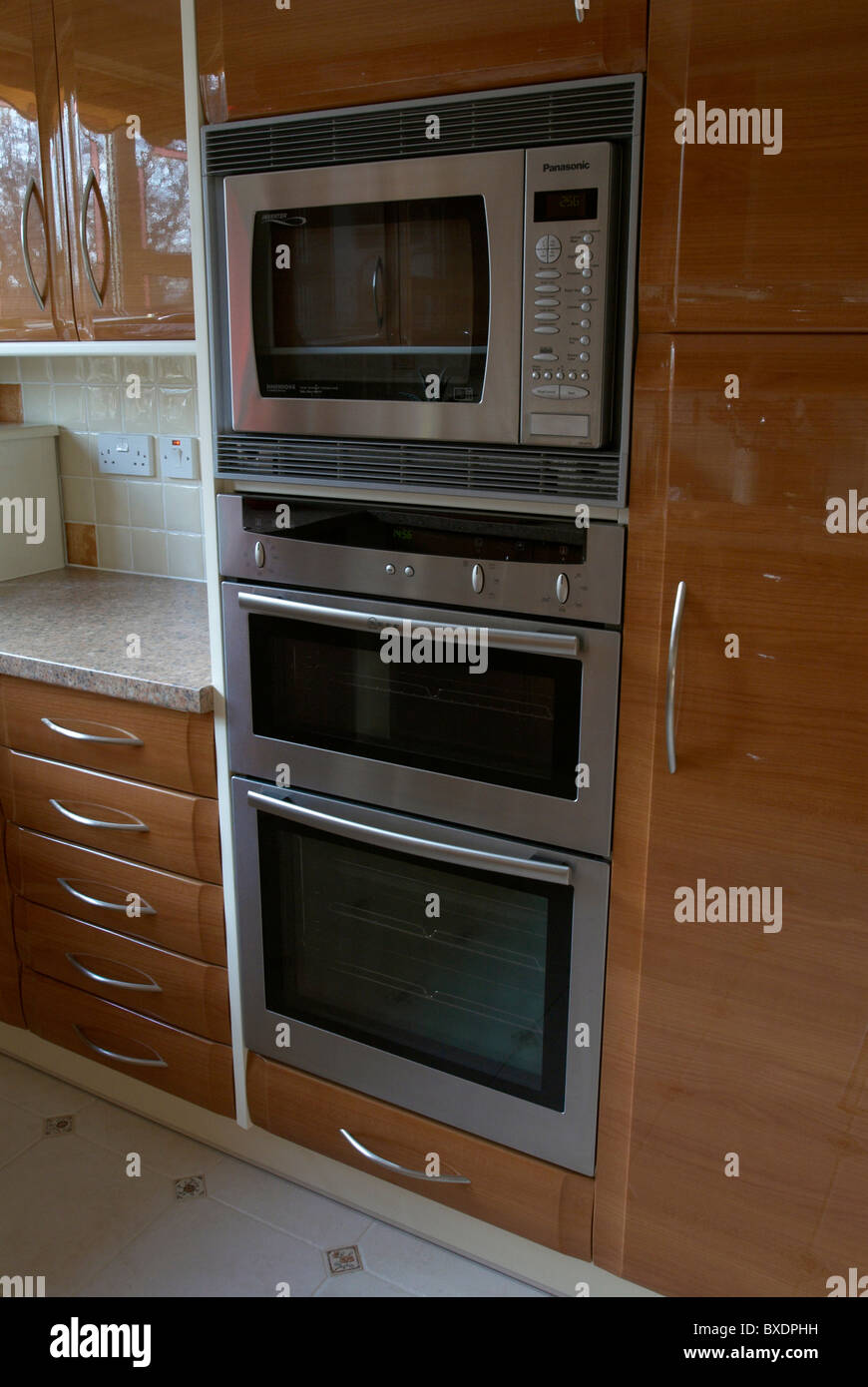 Oven and microwave in new kitchen Stock Photo - Alamy