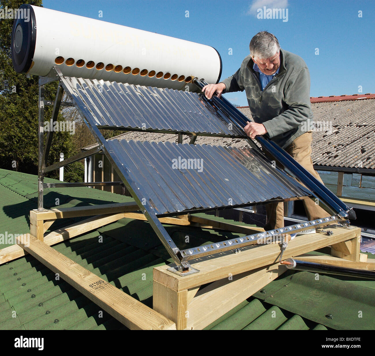 Inserting a solar panel tube to a frame Stock Photo - Alamy