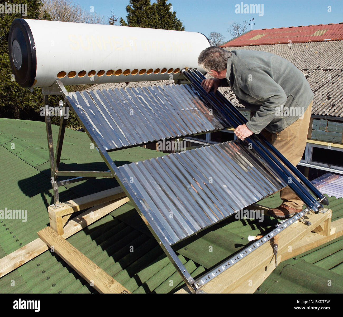 Inserting a solar panel tube to a frame Stock Photo - Alamy