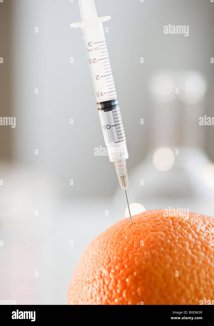 Syringe injecting orange fruit hi-res stock photography and images - Alamy
