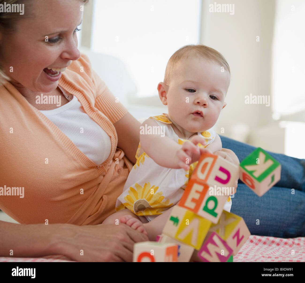 Mother and baby playing with blocks Stock Photo - Alamy
