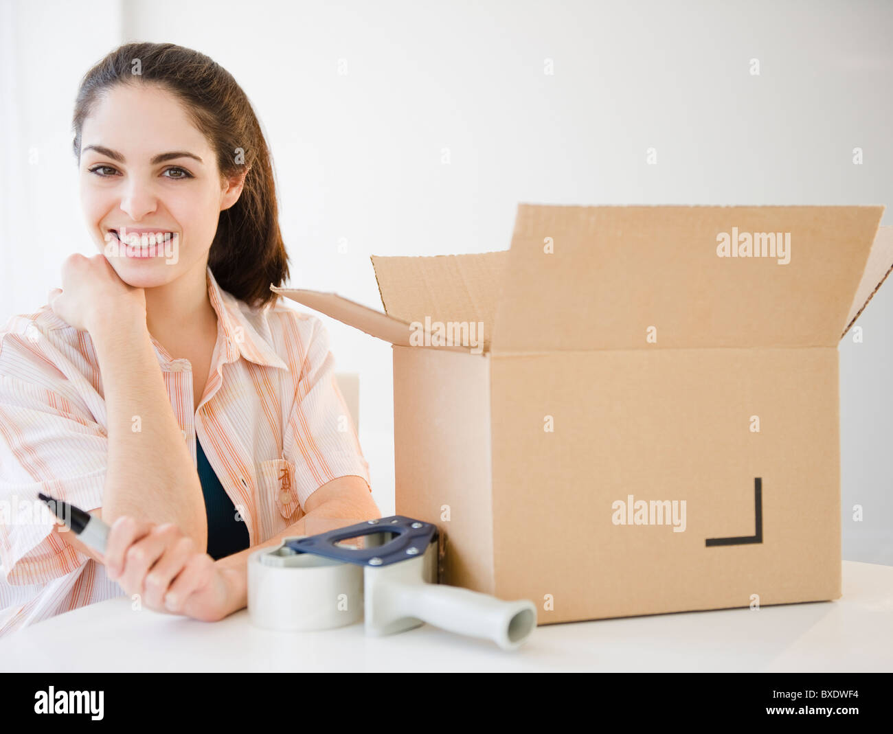 Woman packing boxes Stock Photo - Alamy