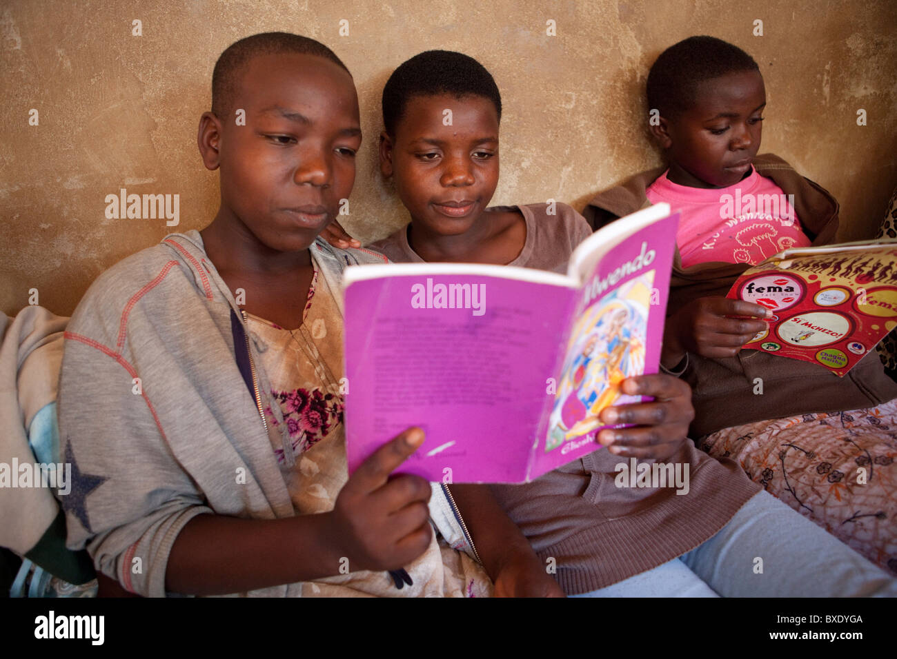Adolescent girls read together at an after school program in Iringa ...