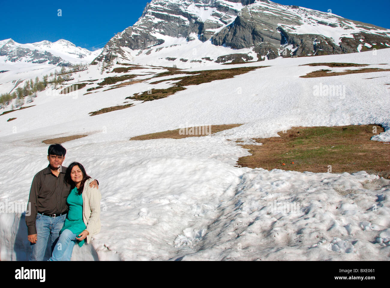 An Indian couple posing near the snow laden hills in Switzerland Stock ...