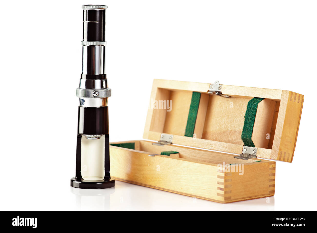 Old fashioned mini microscope and wooden box isolated on white Stock ...