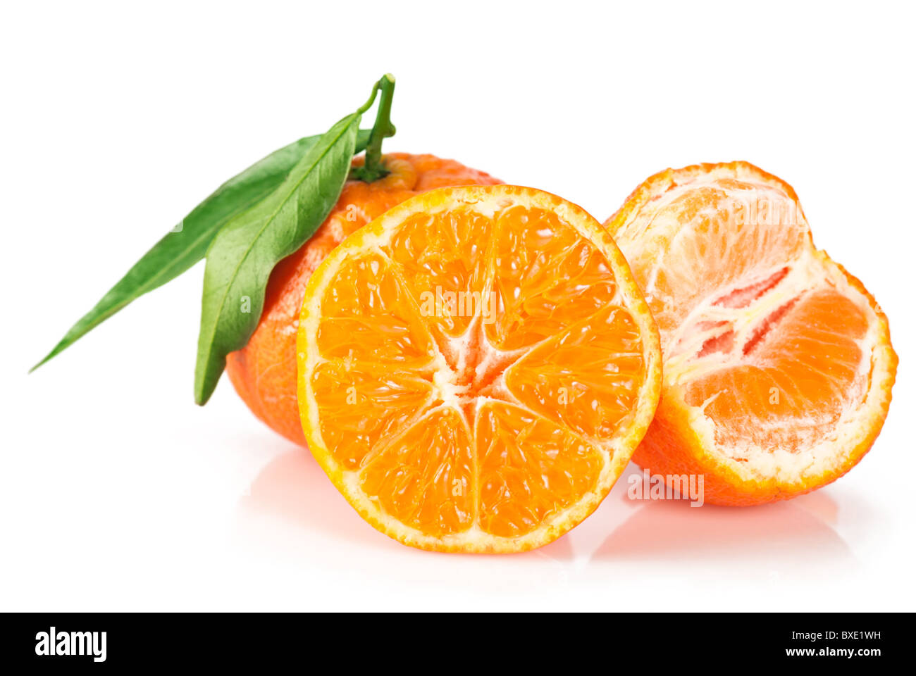 Ripe tangerines with leaves over white background Stock Photo - Alamy