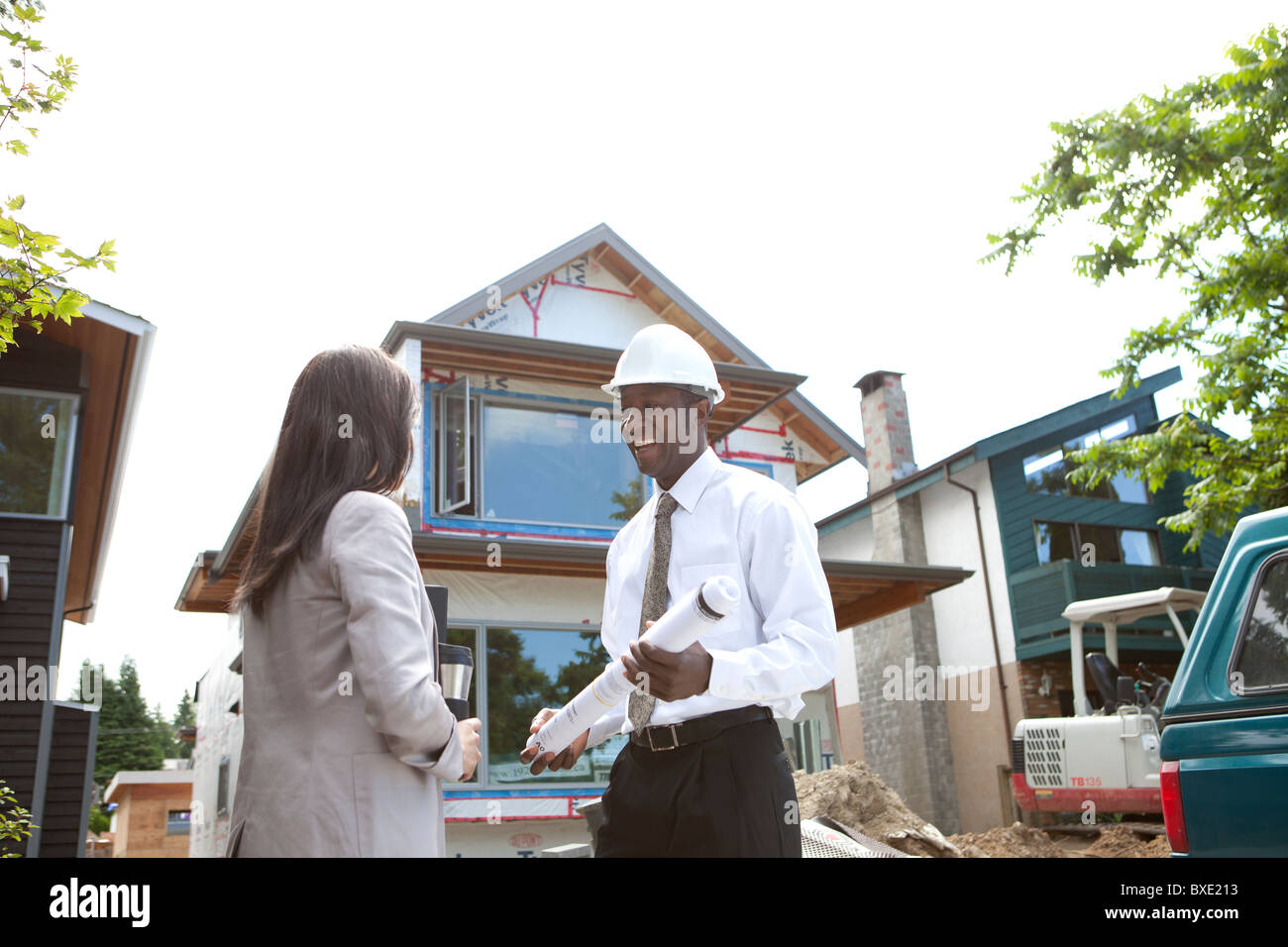 Real estate agents near house under construction Stock Photo - Alamy