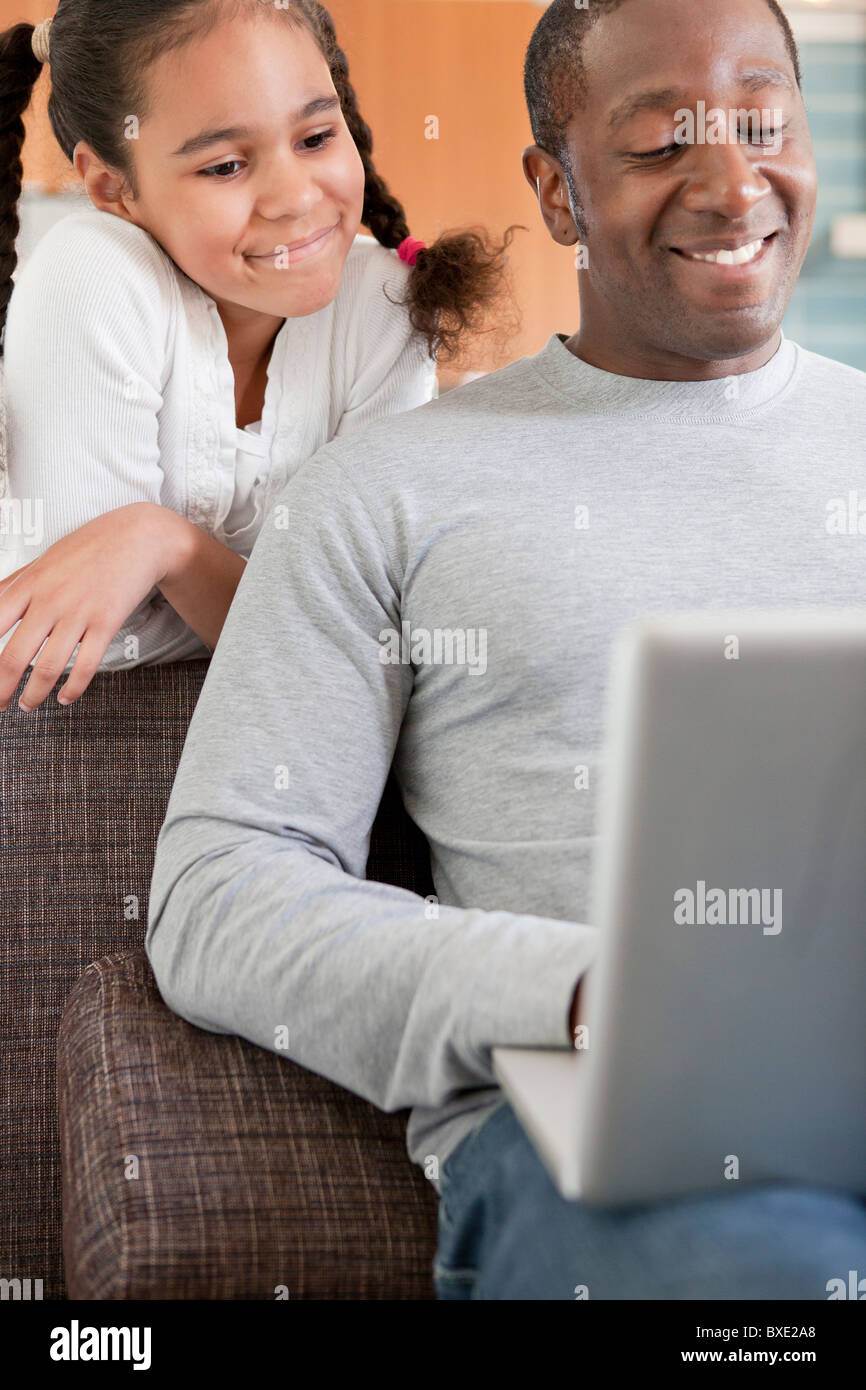 Father and daughter using laptop together Stock Photo - Alamy