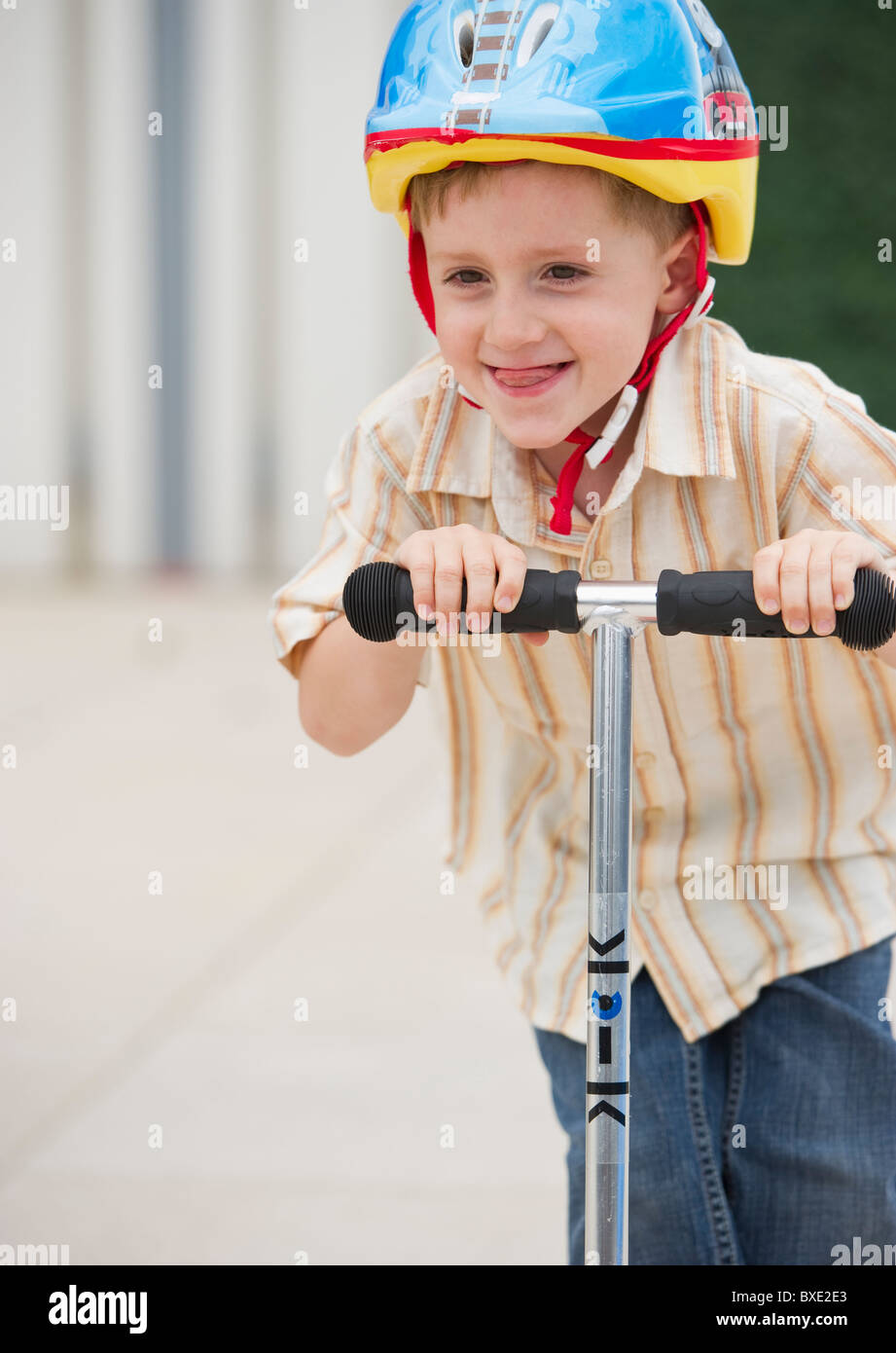 Young boy riding a scooter Stock Photo - Alamy