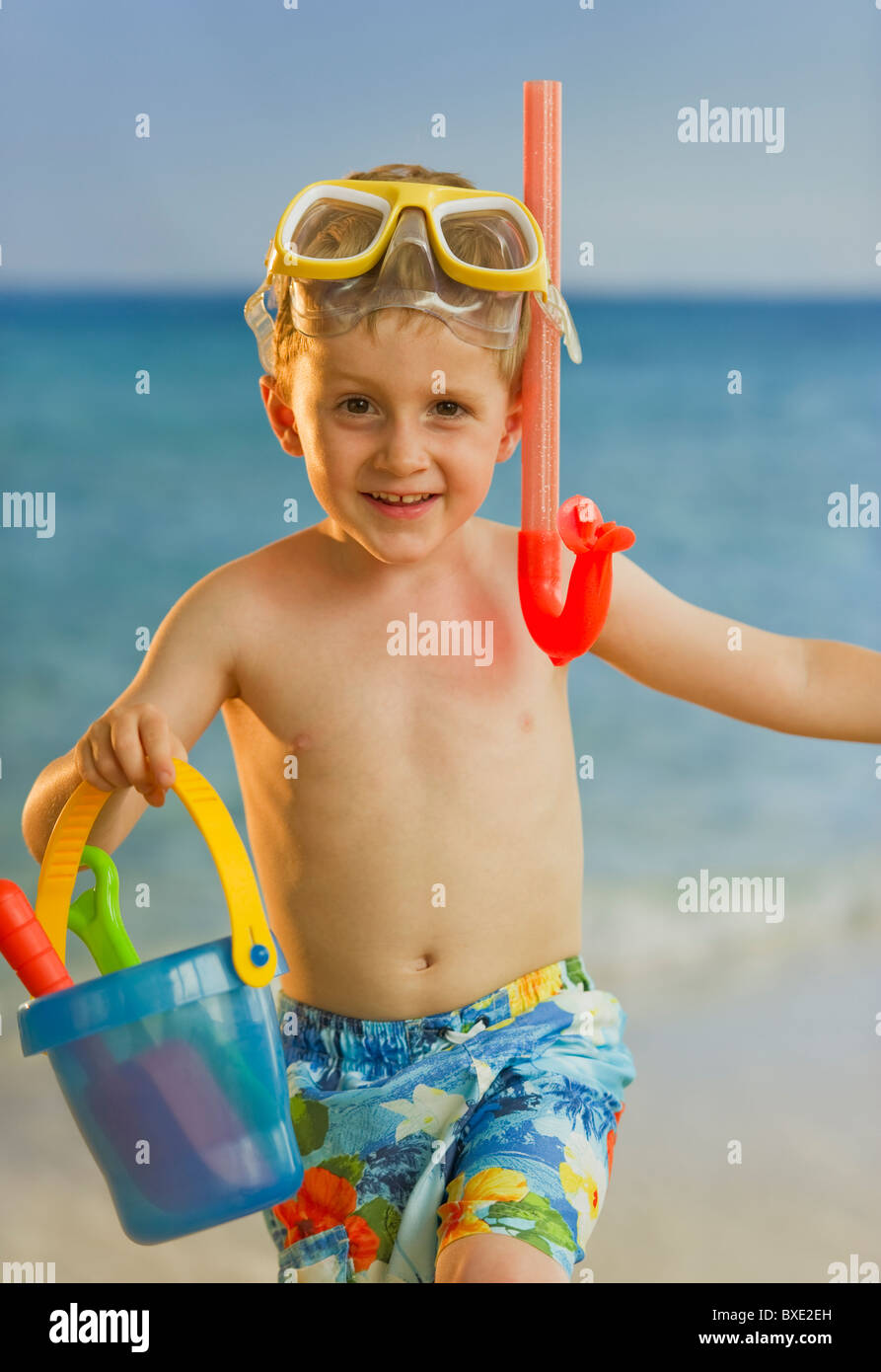 Young boy playing at the beach Stock Photo - Alamy