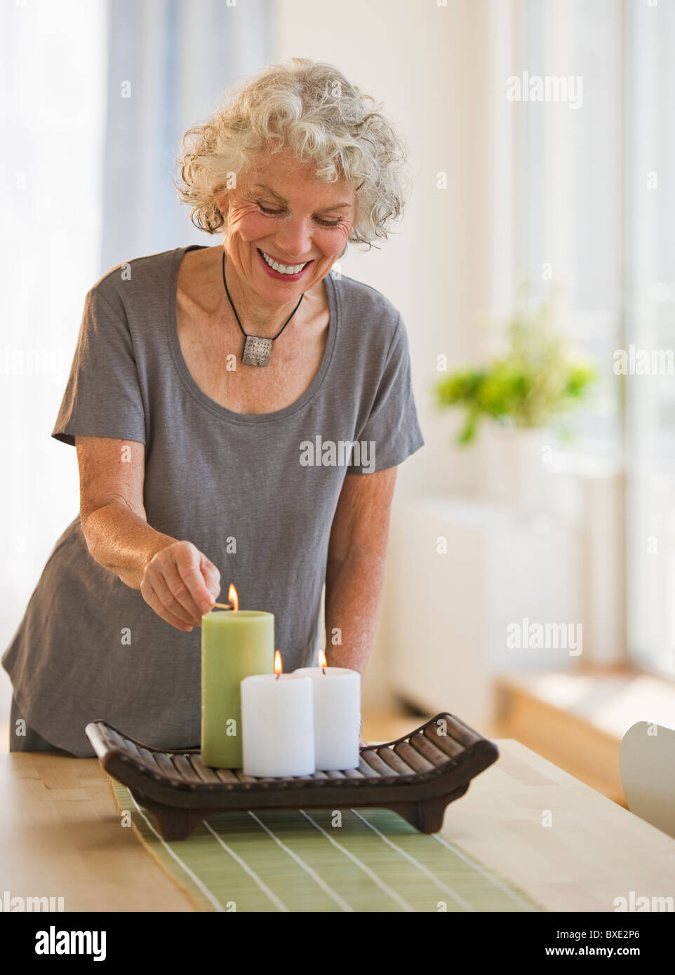 Woman lighting candles Stock Photo - Alamy