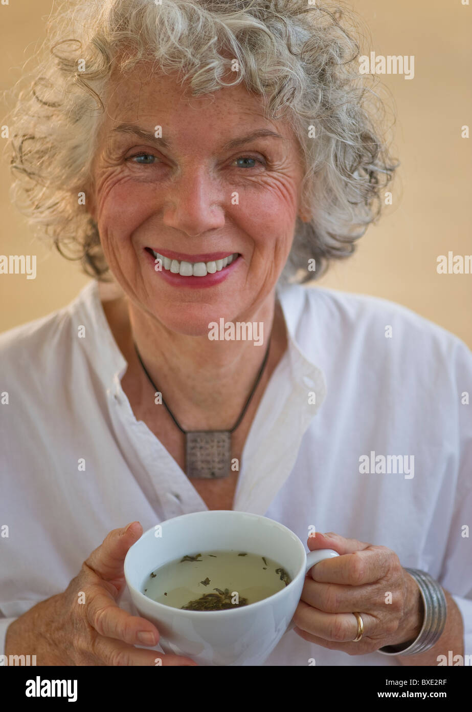 Woman drinking herbal tea Stock Photo - Alamy