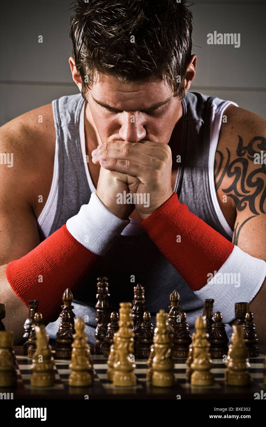 Body builder playing chess Stock Photo - Alamy