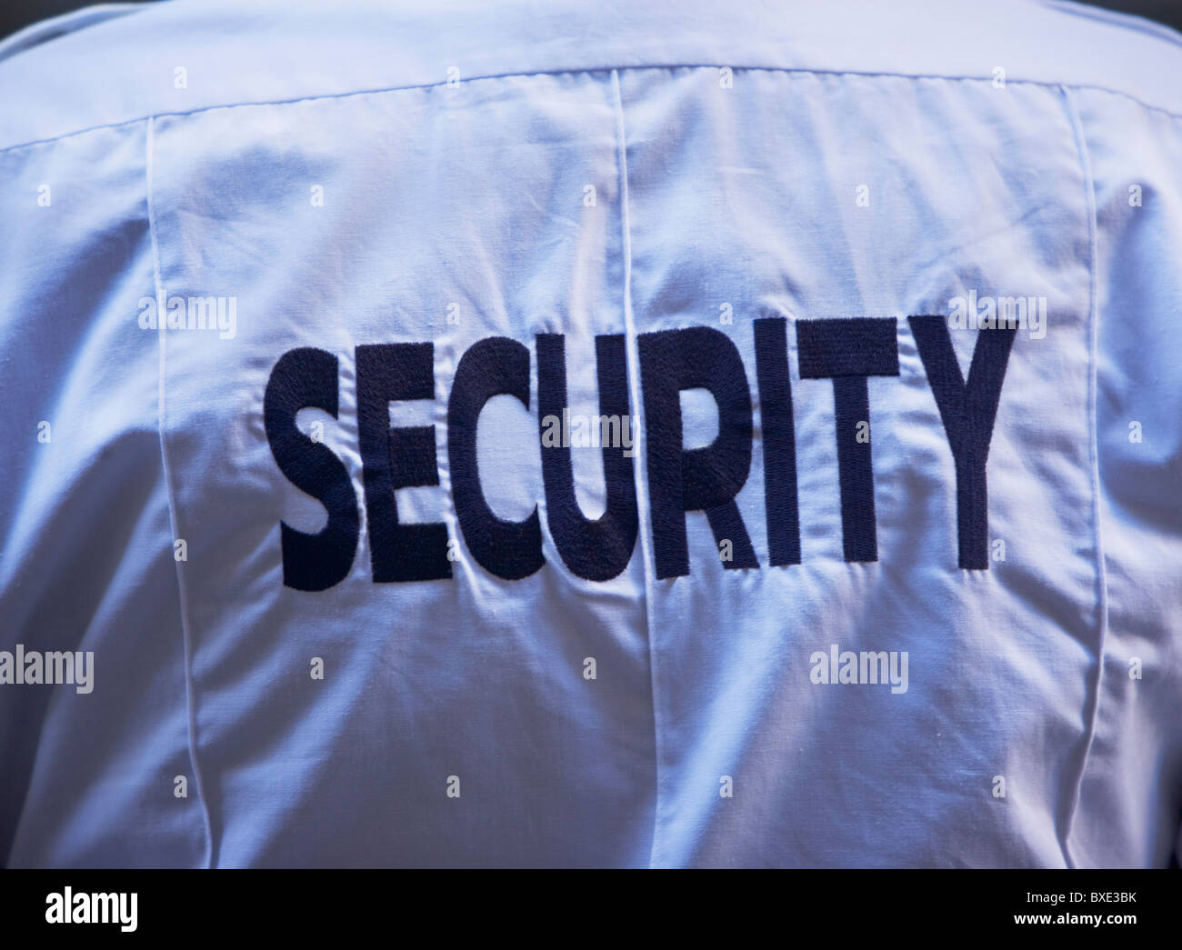 Back of security guard`s shirt Stock Photo - Alamy