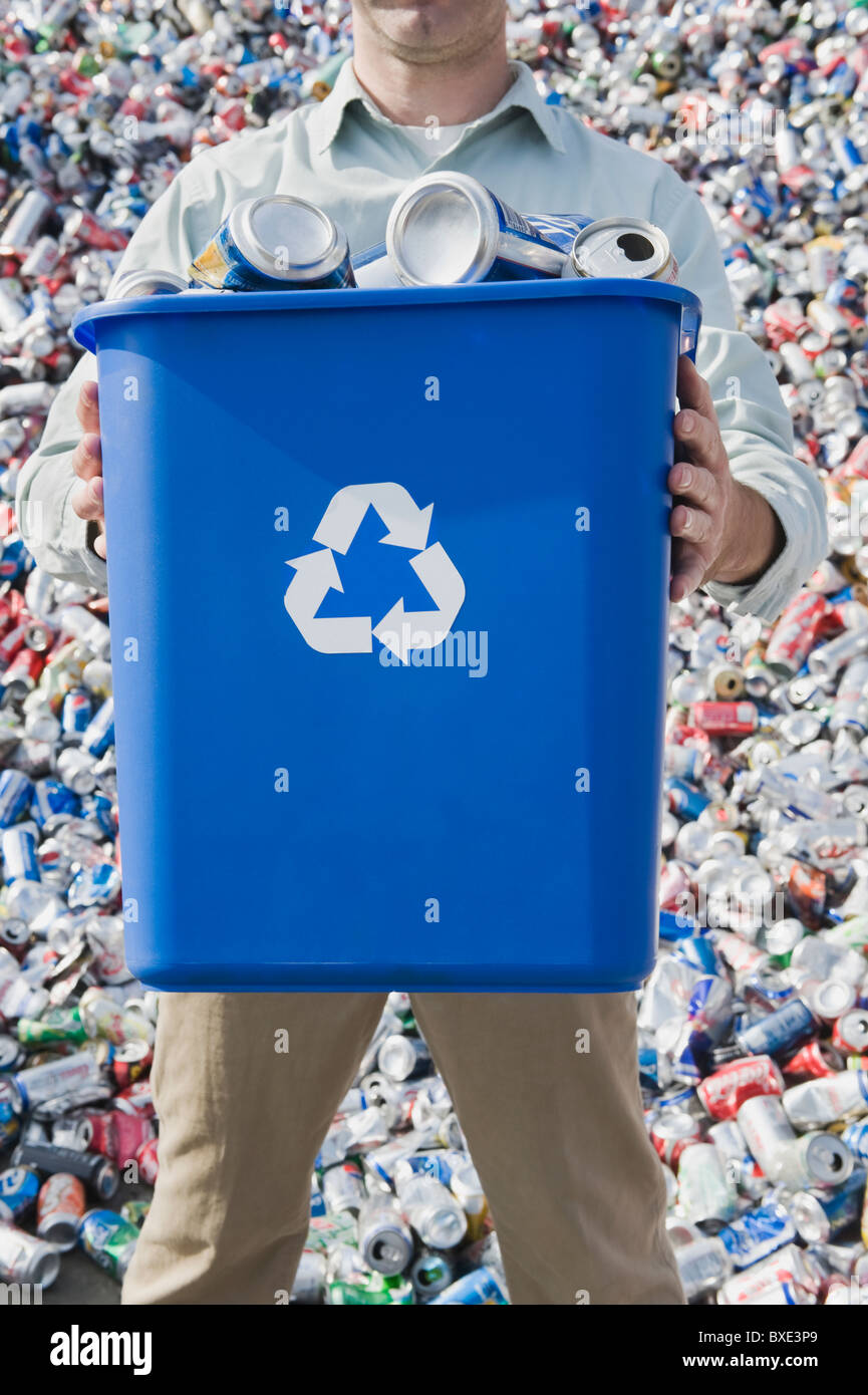 Man holding blue bin Stock Photo - Alamy