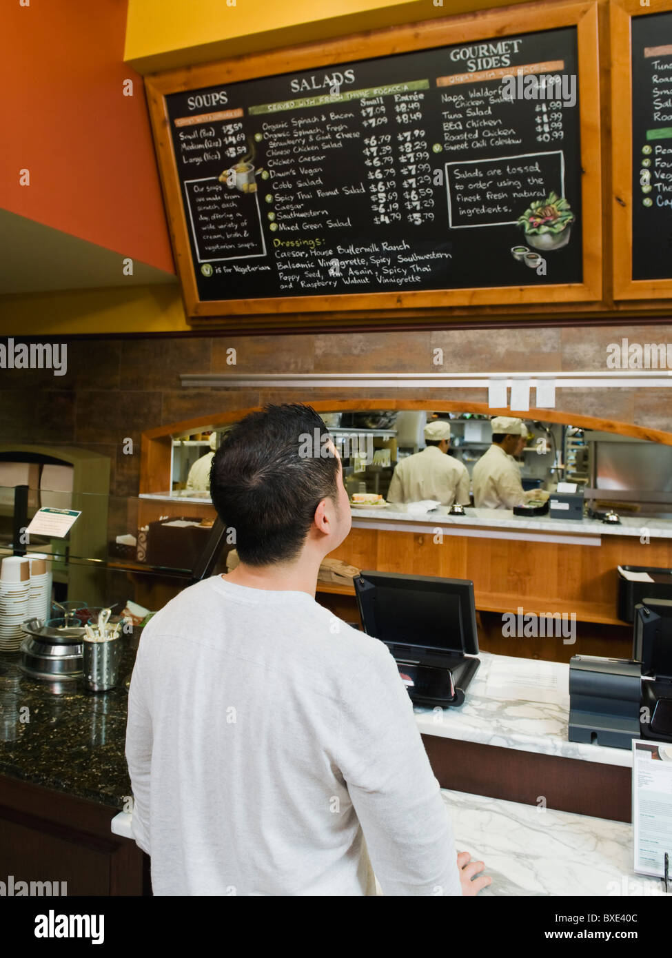 Customer reading chalkboard menu Stock Photo - Alamy
