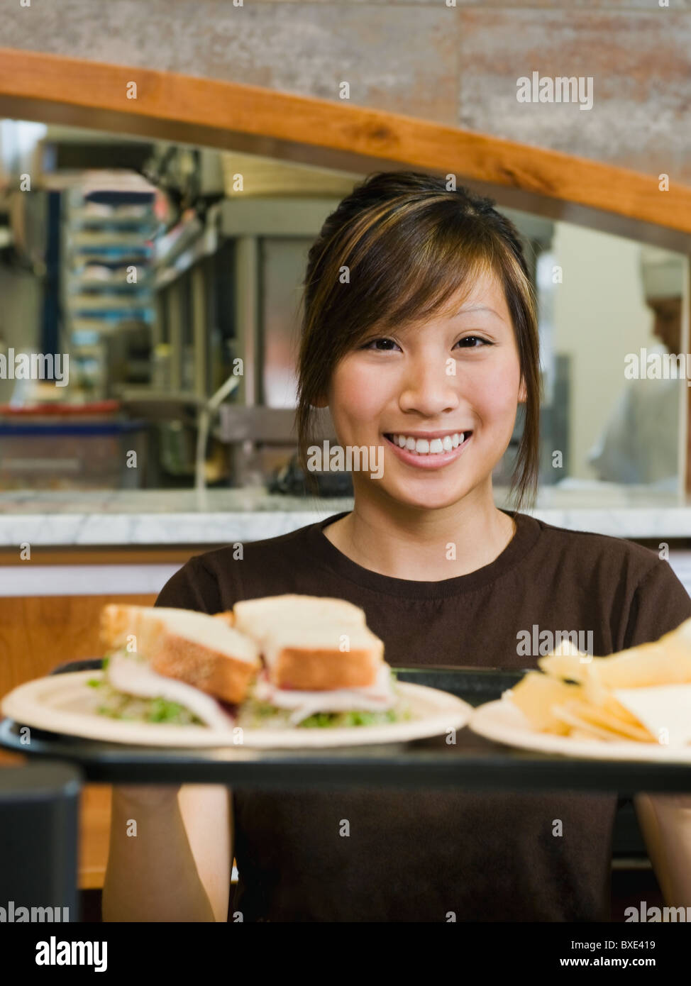 Woman holding tray of food Stock Photo - Alamy