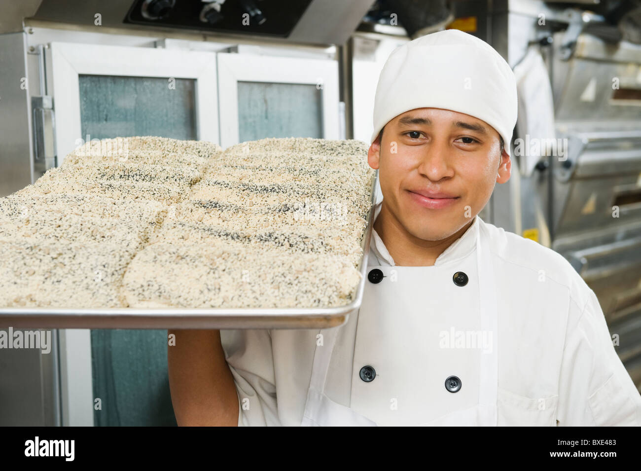 Chef holding tray of bread Stock Photo - Alamy