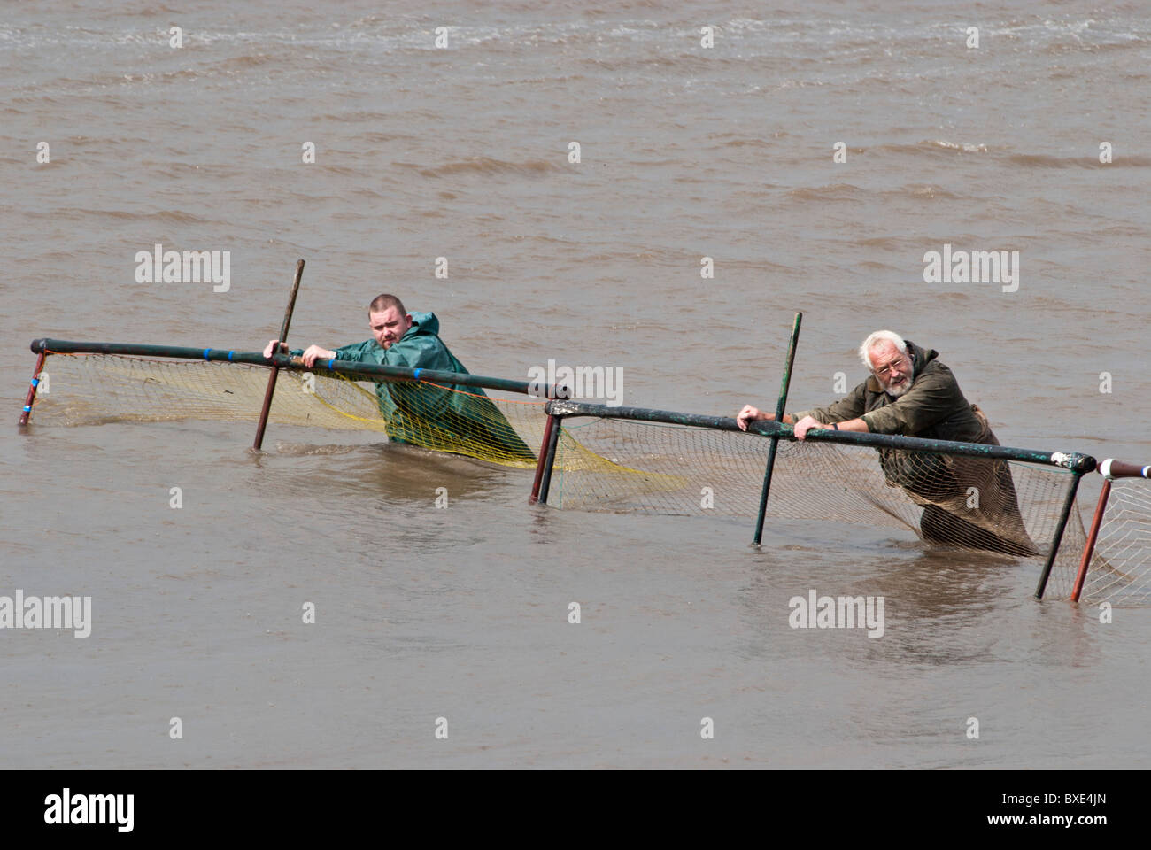 2 men Haaf netting for Salmon on River Nith estuary Glencaple, Dumfries ...