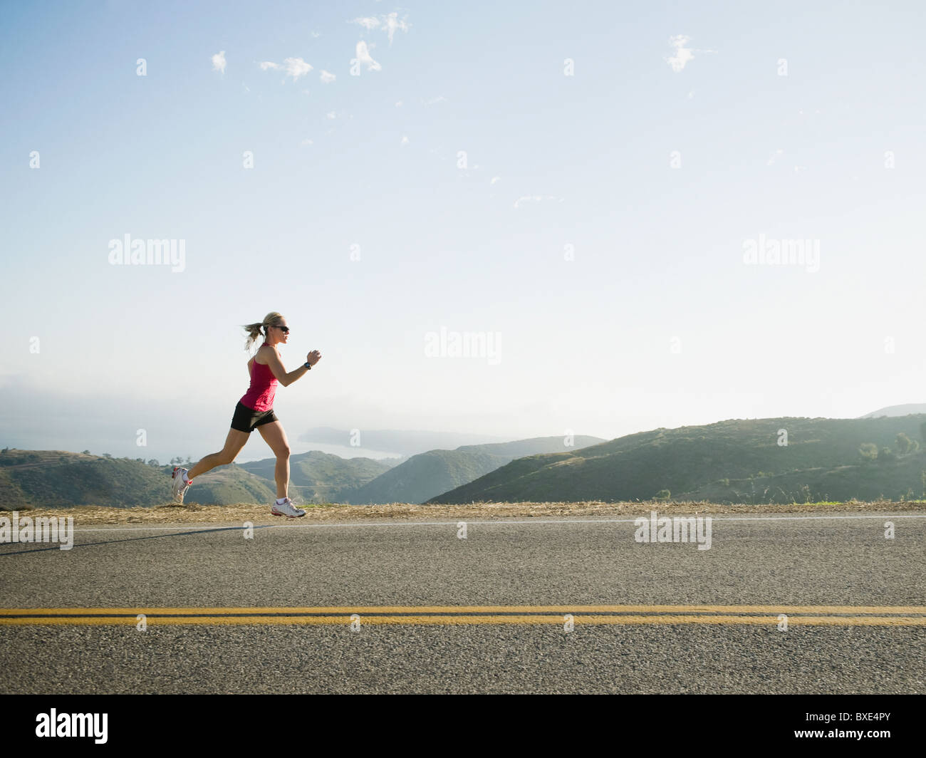 Runner training on the side of the road Stock Photo - Alamy