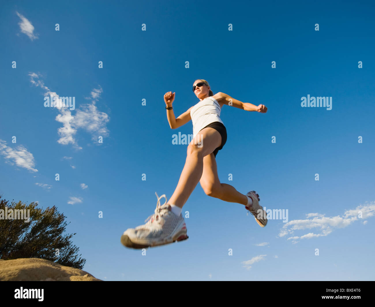 Trail runner jumping Stock Photo - Alamy
