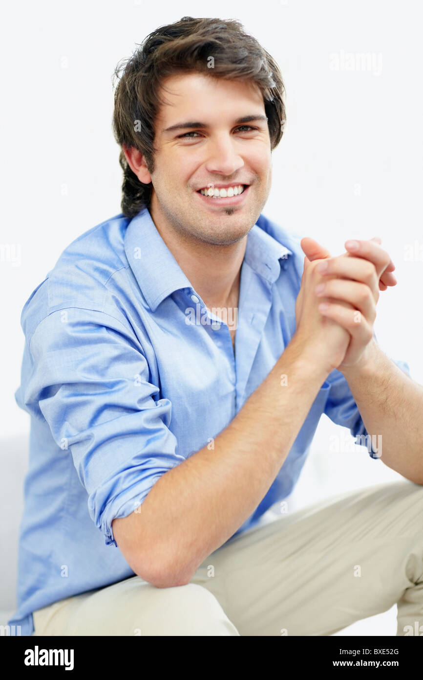 Handsome man sitting with hands clasped Stock Photo - Alamy