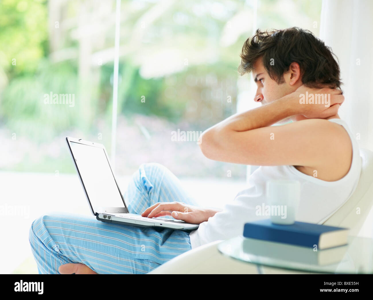 Relaxed man browsing the internet Stock Photo - Alamy