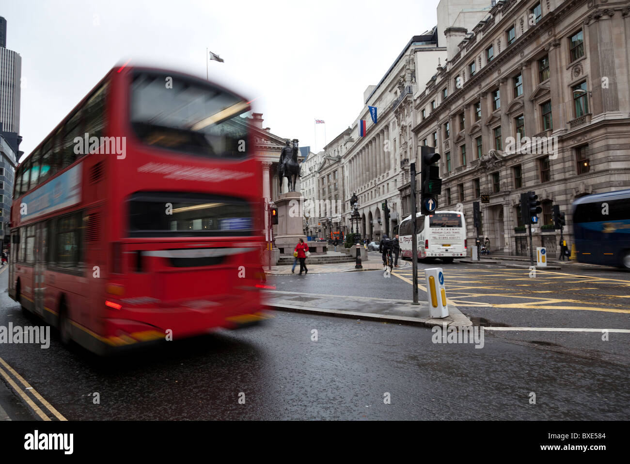 A London bus speeds across a road junction in front of the Royal ...