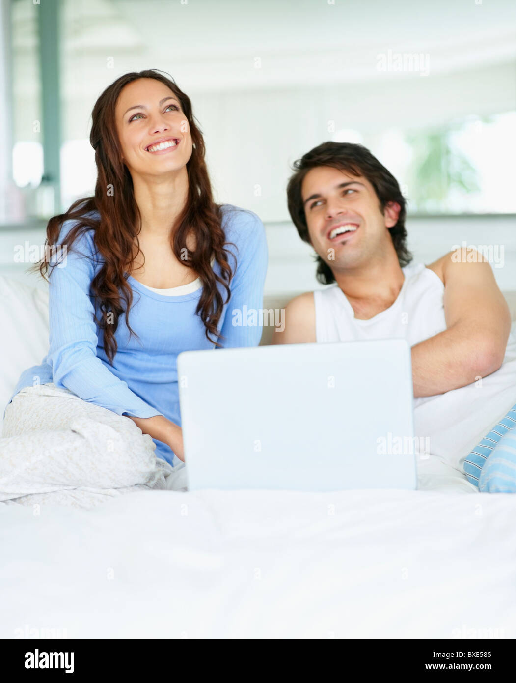 Couple looking at laptop together Stock Photo - Alamy