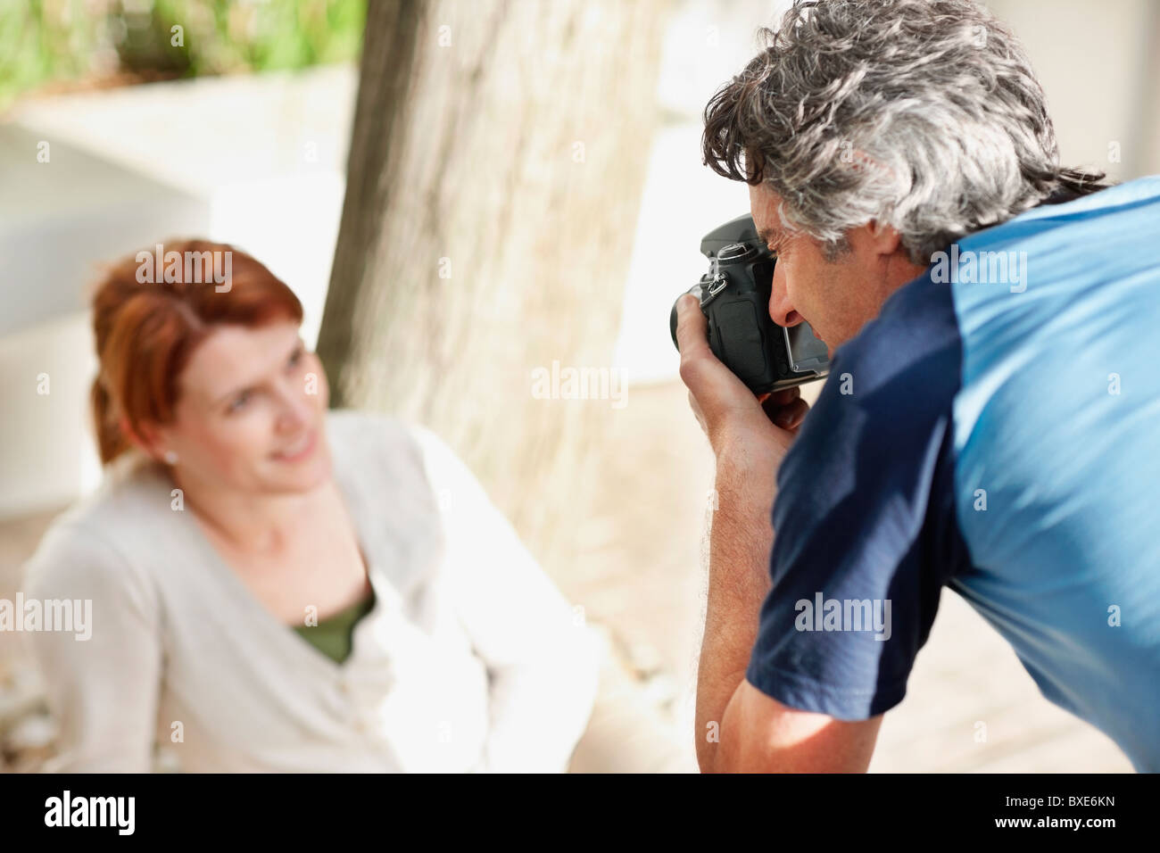 Man taking picture of woman Stock Photo - Alamy