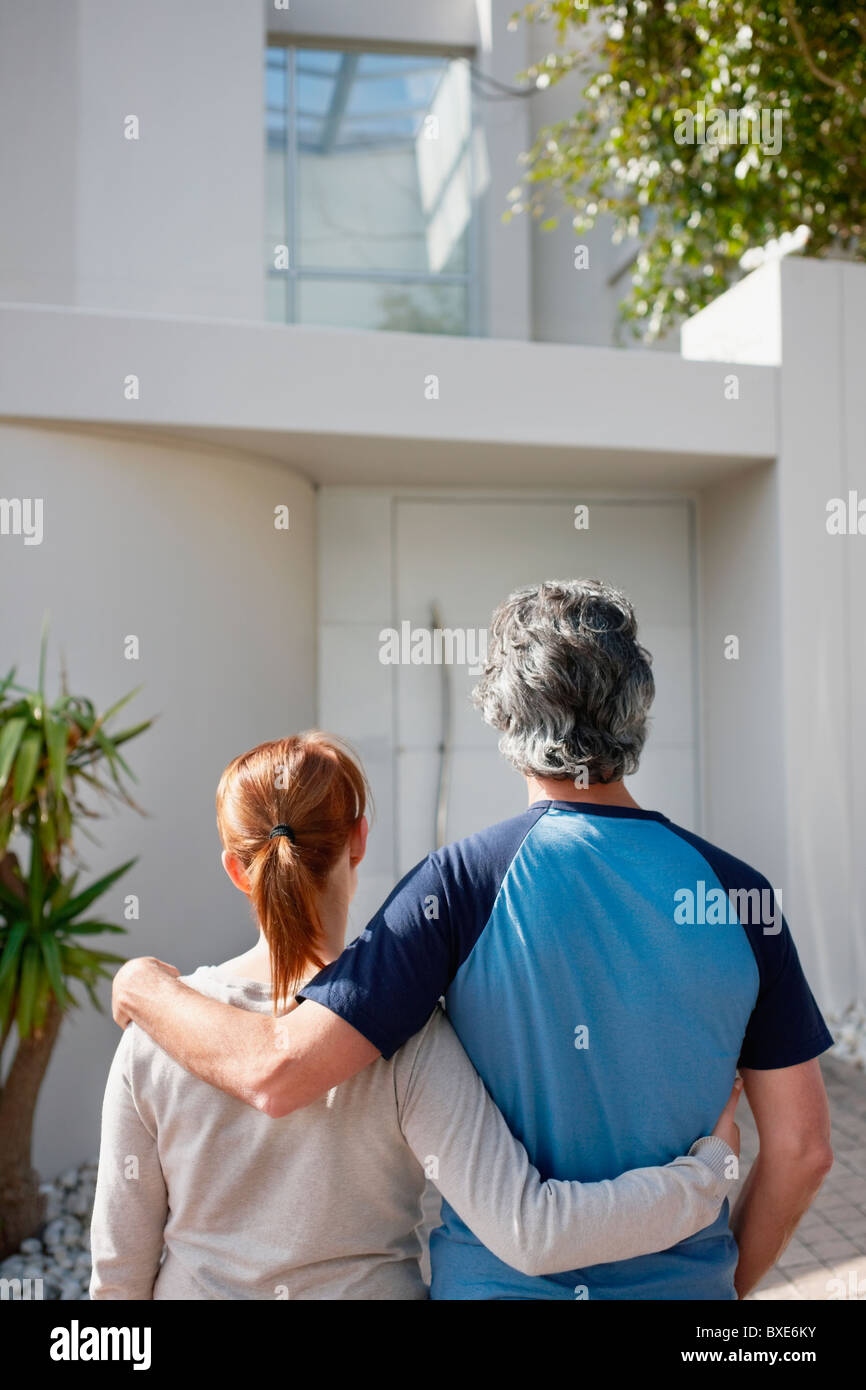 Couple looking at their home Stock Photo - Alamy