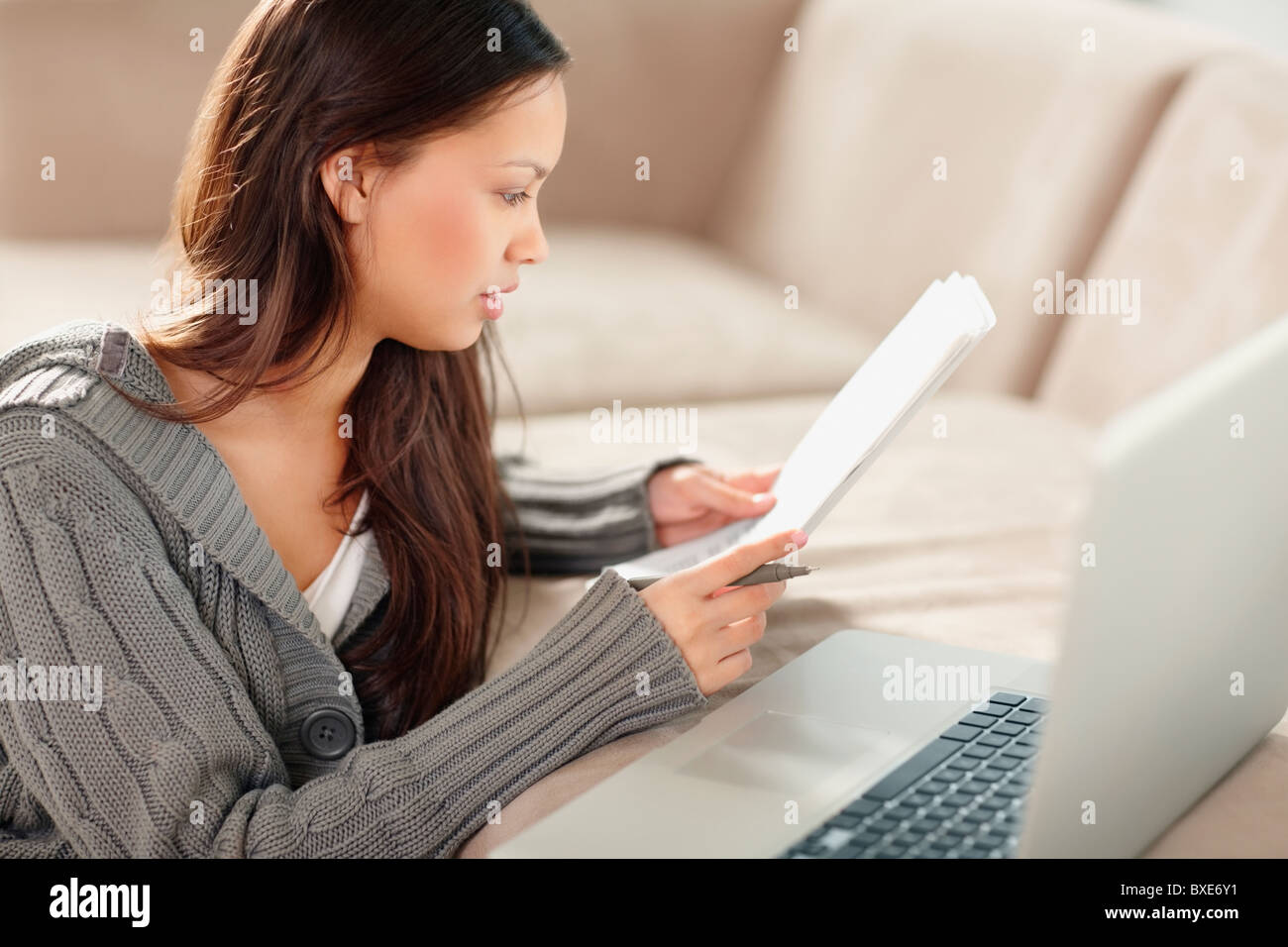 Woman reading paperwork Stock Photo - Alamy