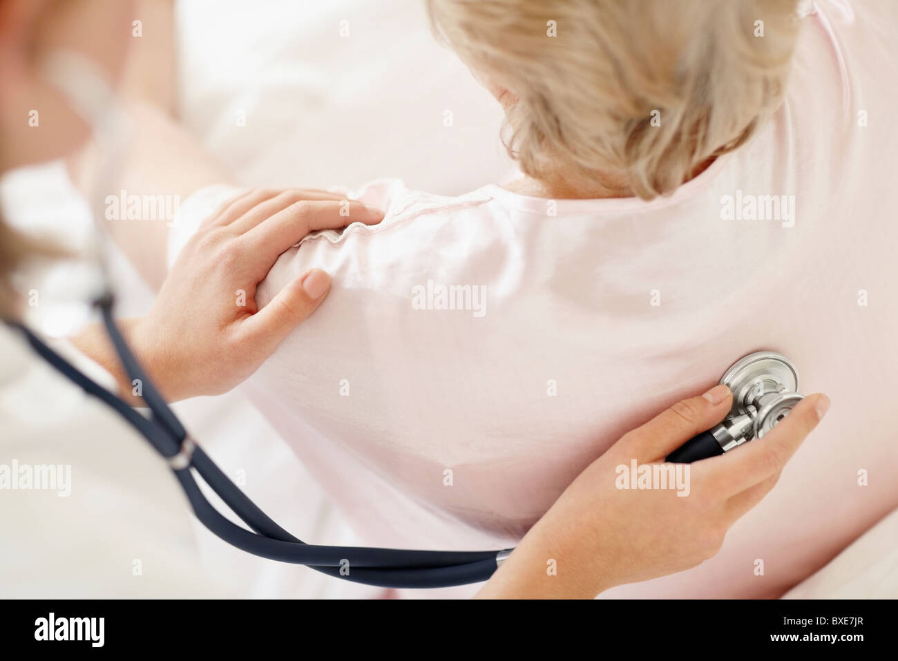 Nurse examining patient with a stethoscope Stock Photo - Alamy