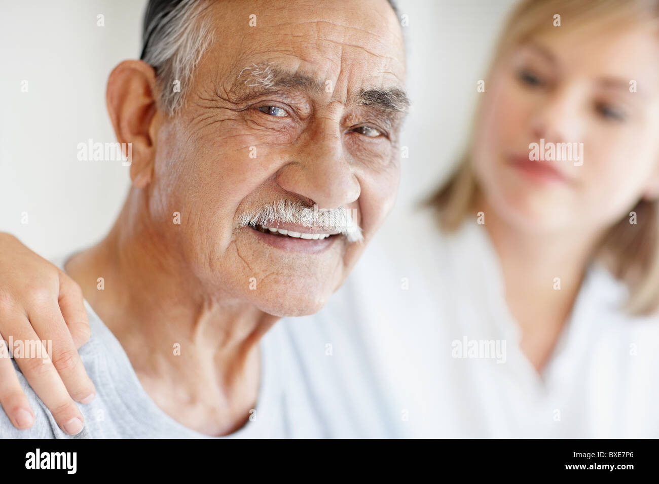 Nurse caring for senior patient Stock Photo - Alamy