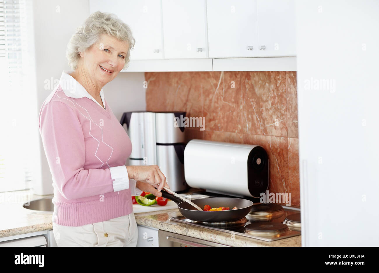 Senior woman cooking Stock Photo - Alamy