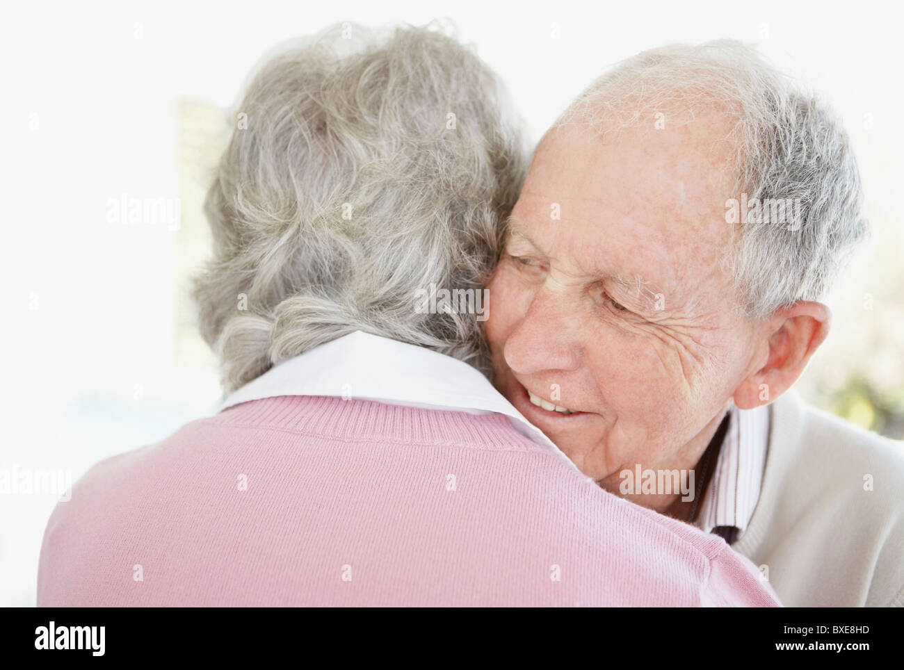 Senior couple hugging Stock Photo - Alamy