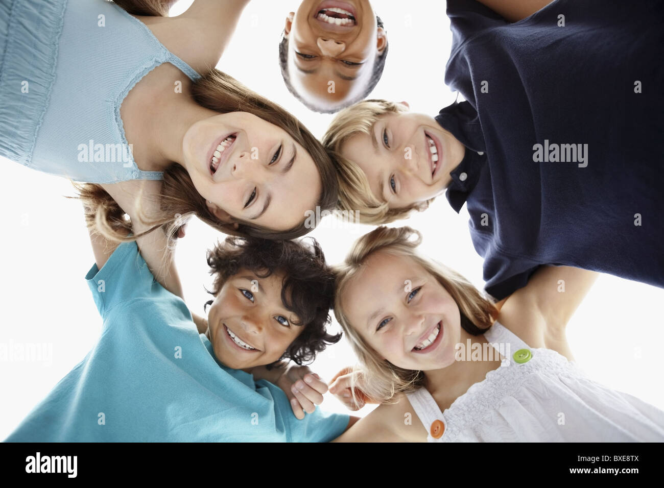 Happy children huddled together Stock Photo - Alamy