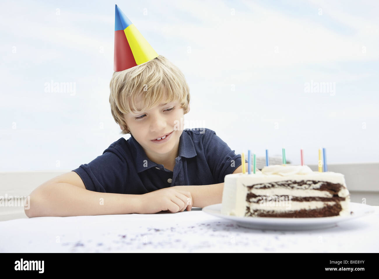 Young boy waiting for a slice of birthday cake Stock Photo - Alamy