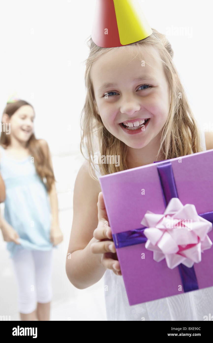 Birthday girl holding a gift Stock Photo - Alamy