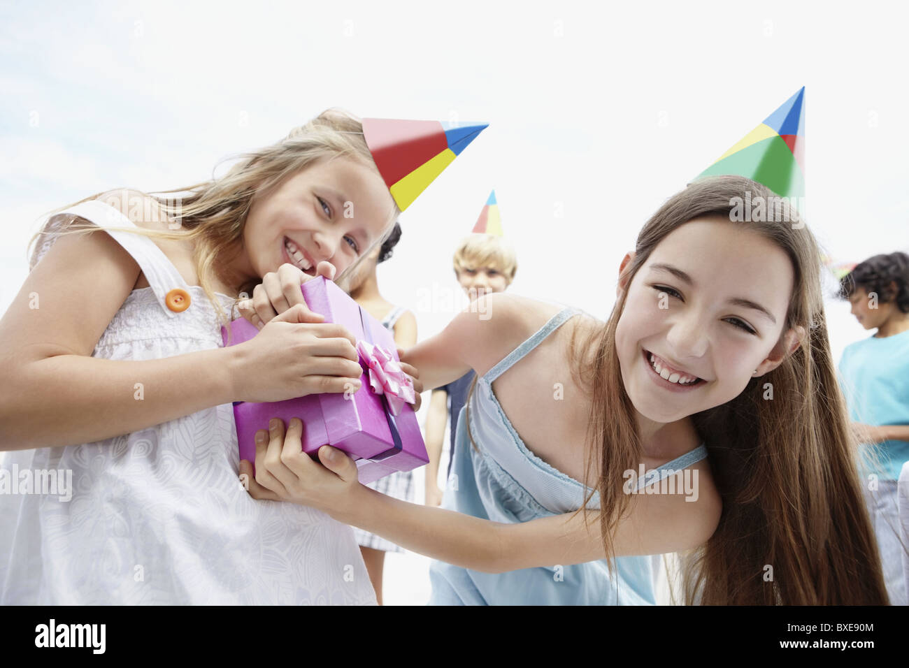 Two girls fighting over birthday present Stock Photo - Alamy