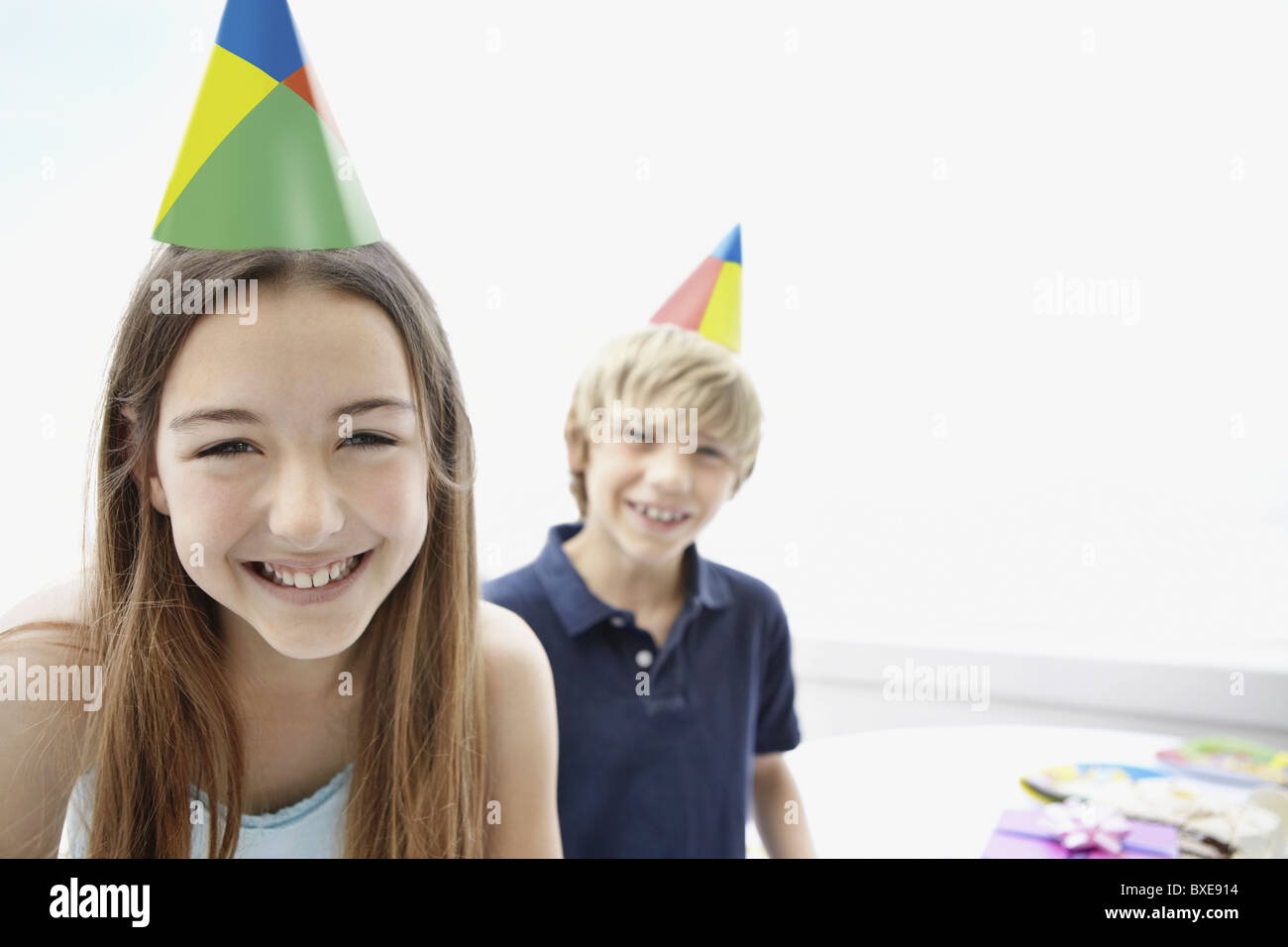 Two children wearing birthday hats Stock Photo - Alamy