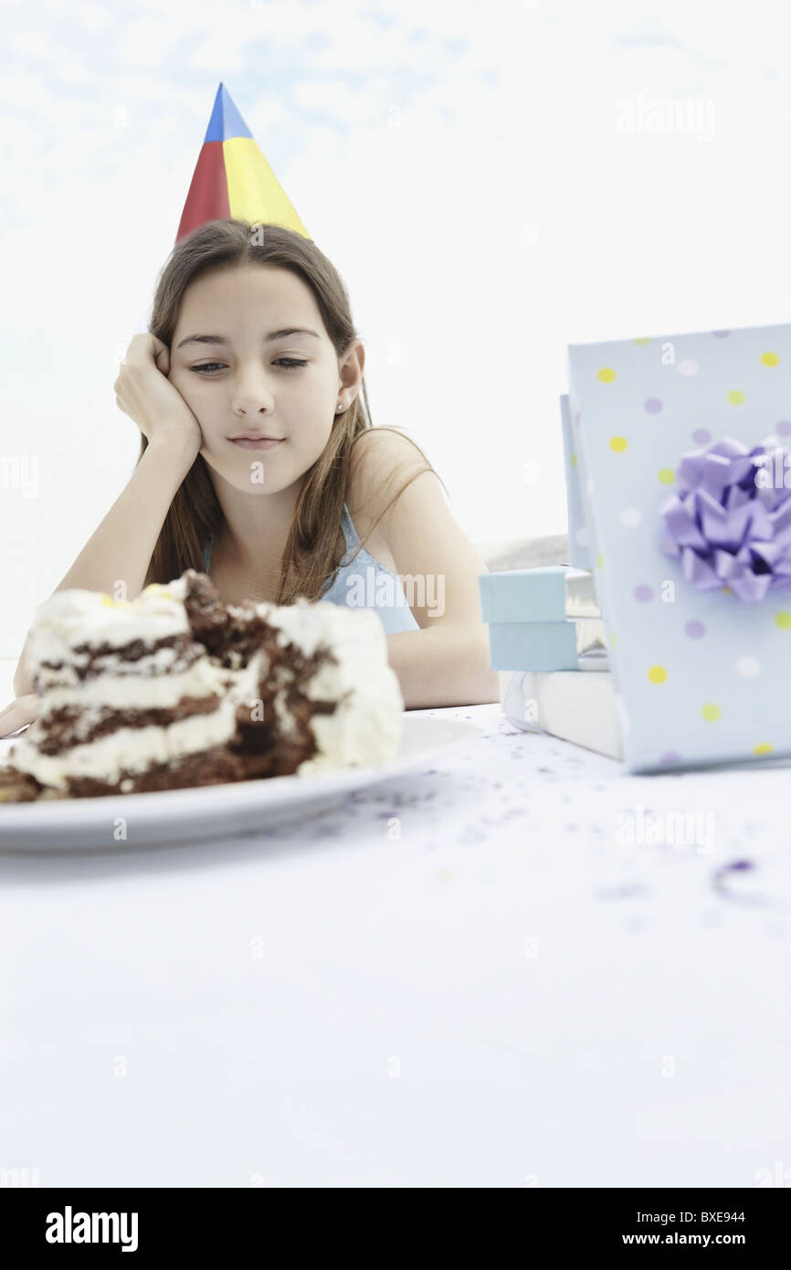 Young girl staring at birthday cake Stock Photo - Alamy