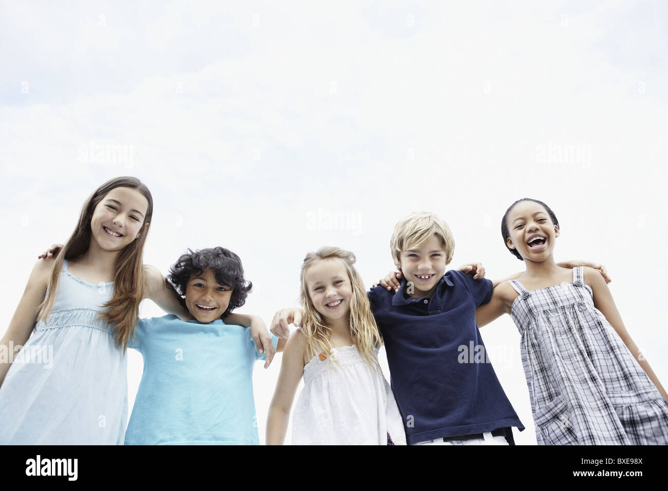 Young children with their arms around one another Stock Photo - Alamy