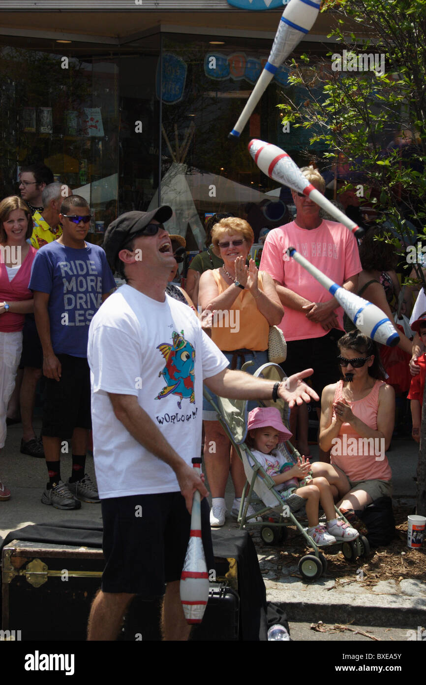 People watch a street performer juggle at the Watermelon Festival in ...